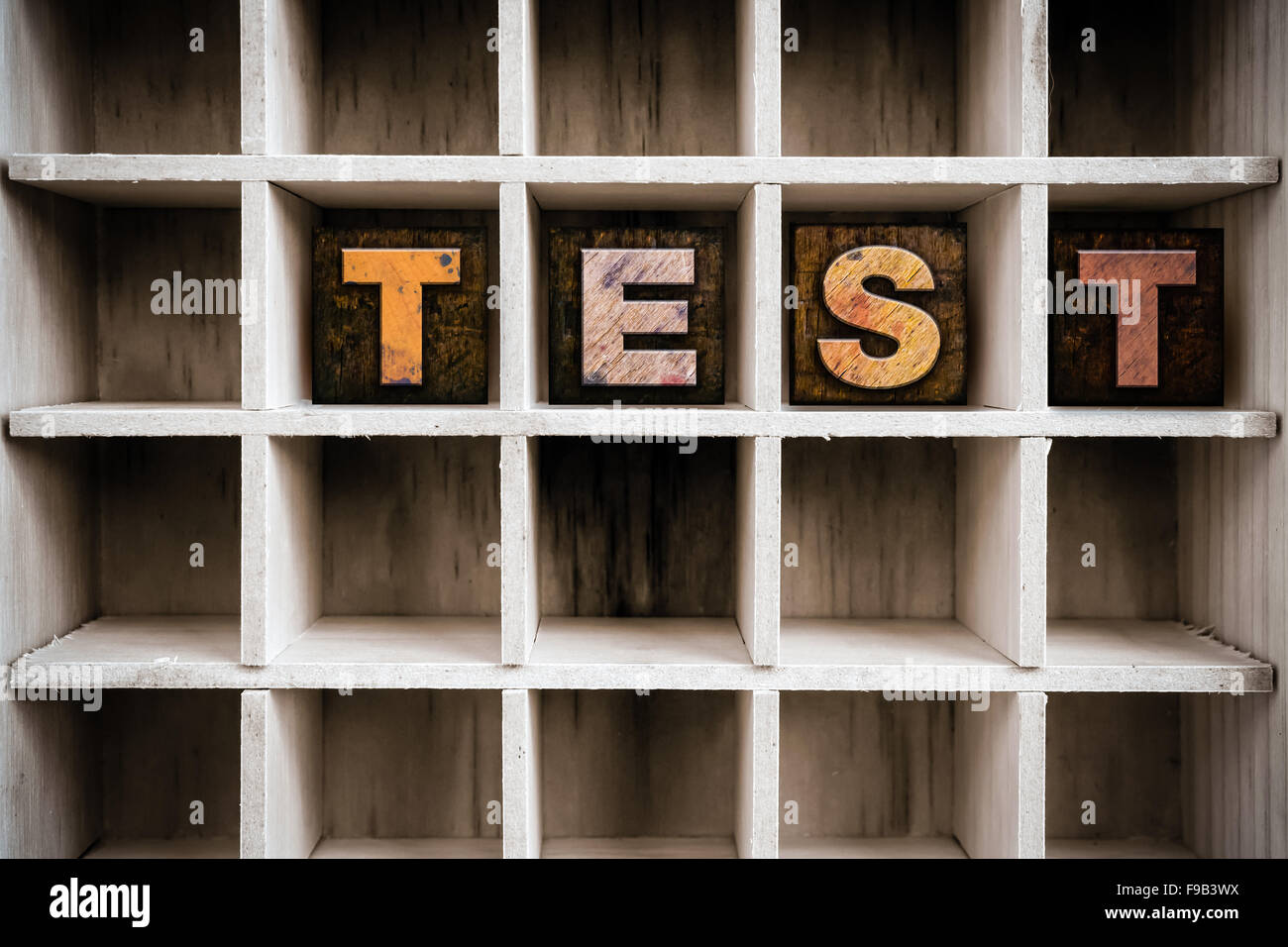 The word "TEST" written in vintage ink stained wooden letterpress type ...