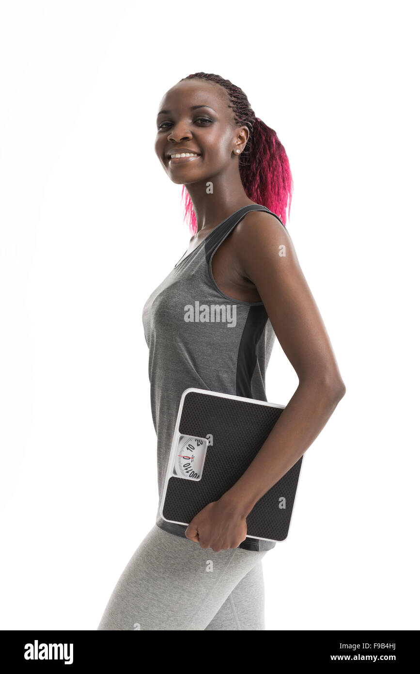 Beautiful young healthy african woman holding scales. Diet. Isolated on ...