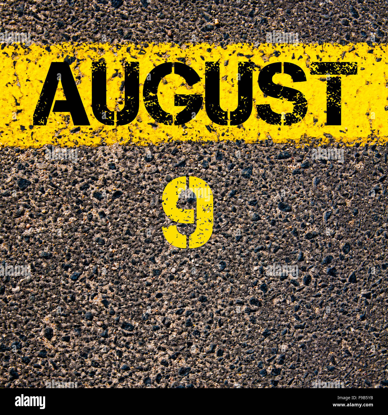 9 August calendar day written over road marking yellow paint line Stock ...