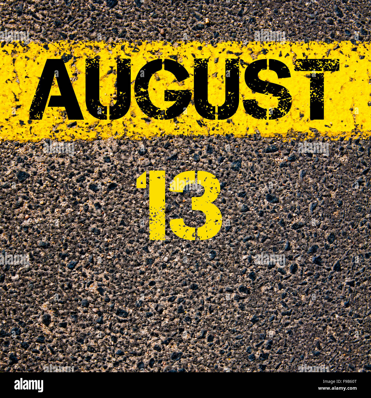 13 August calendar day written over road marking yellow paint line ...