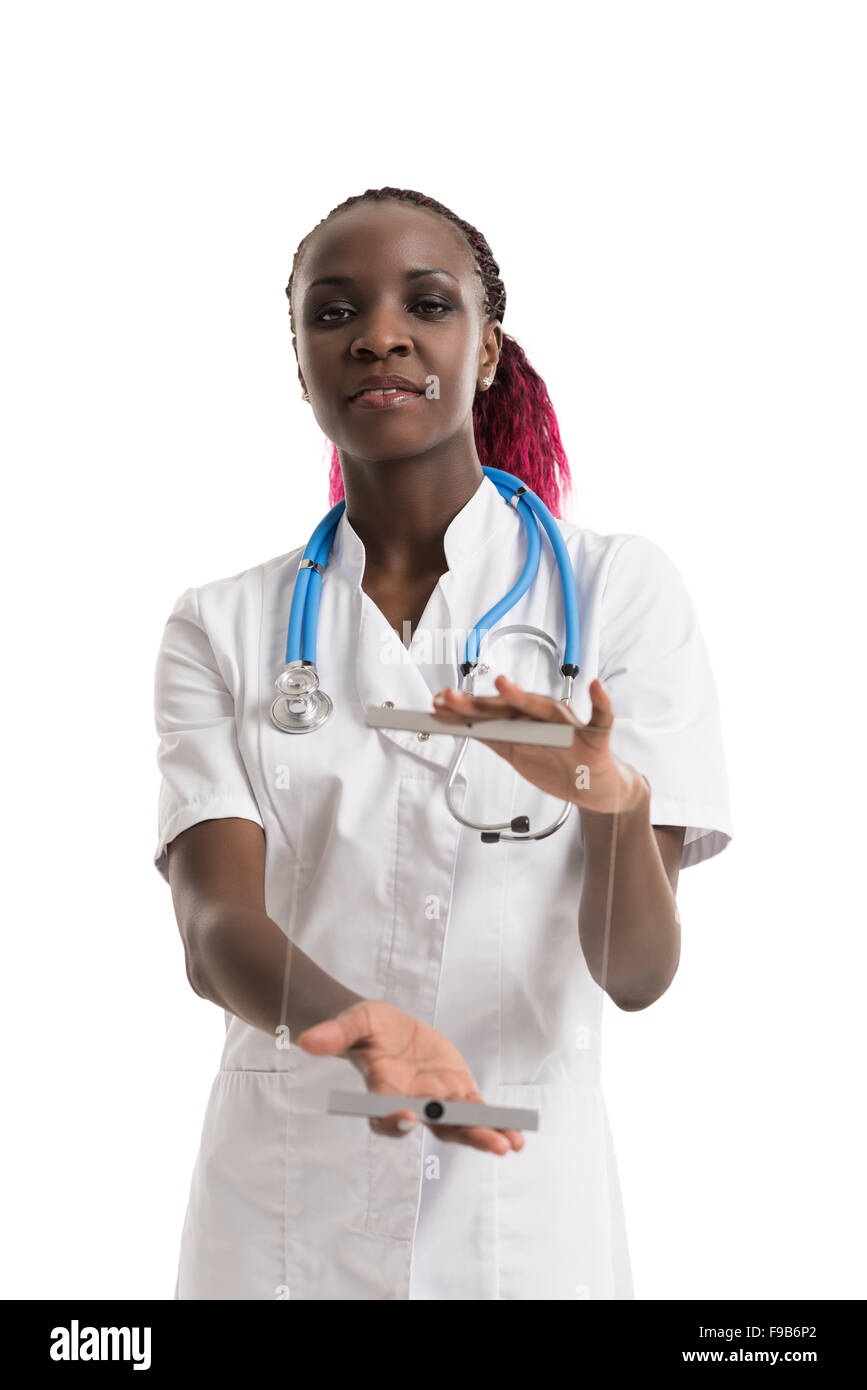 Smiling african doctor using a tablet computer on white background ...