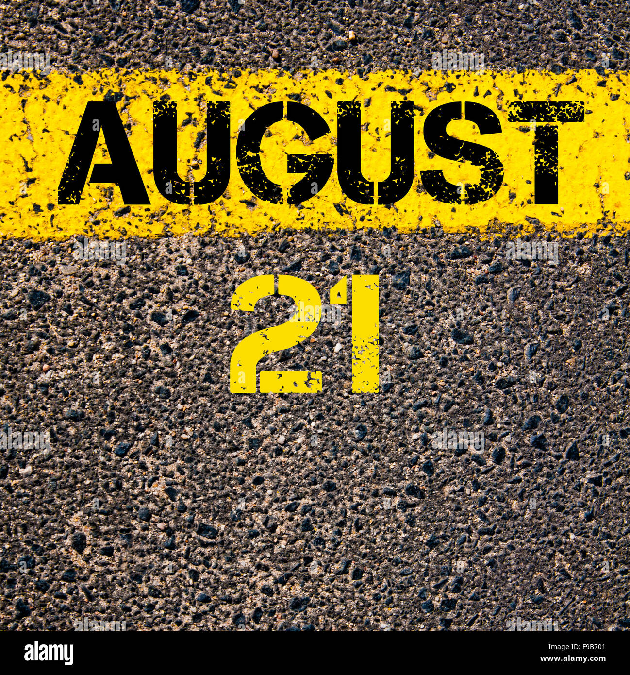 21 August calendar day written over road marking yellow paint line ...
