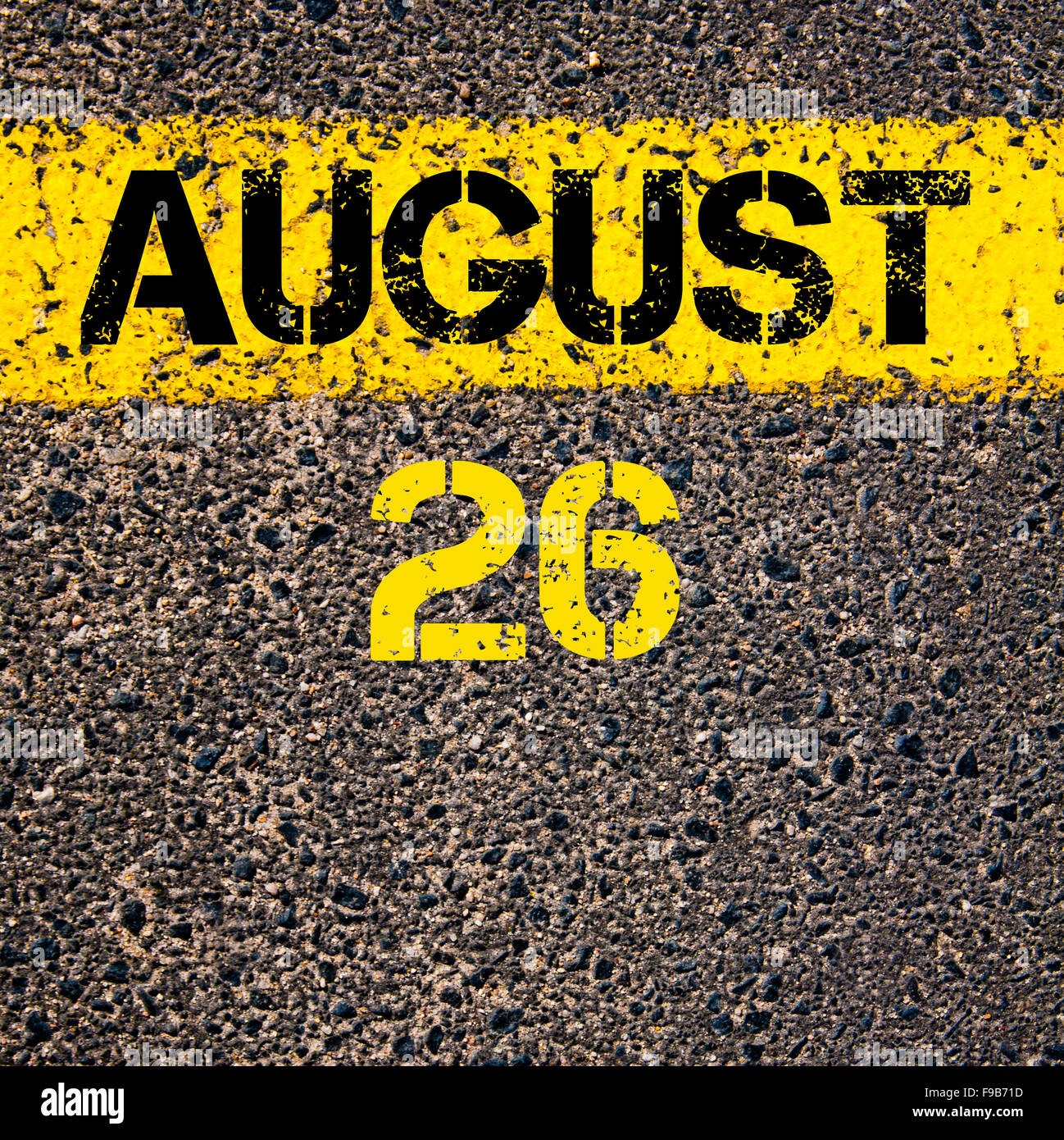 26 August calendar day written over road marking yellow paint line ...