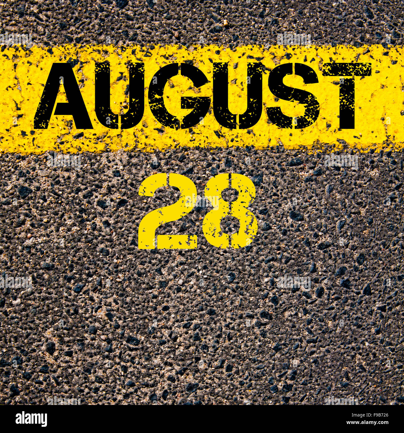 28 August calendar day written over road marking yellow paint line ...