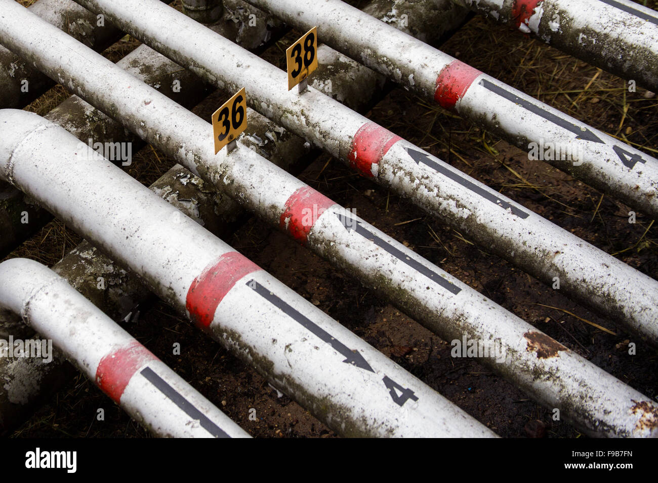 array of old pipes with painted arrows Stock Photo - Alamy