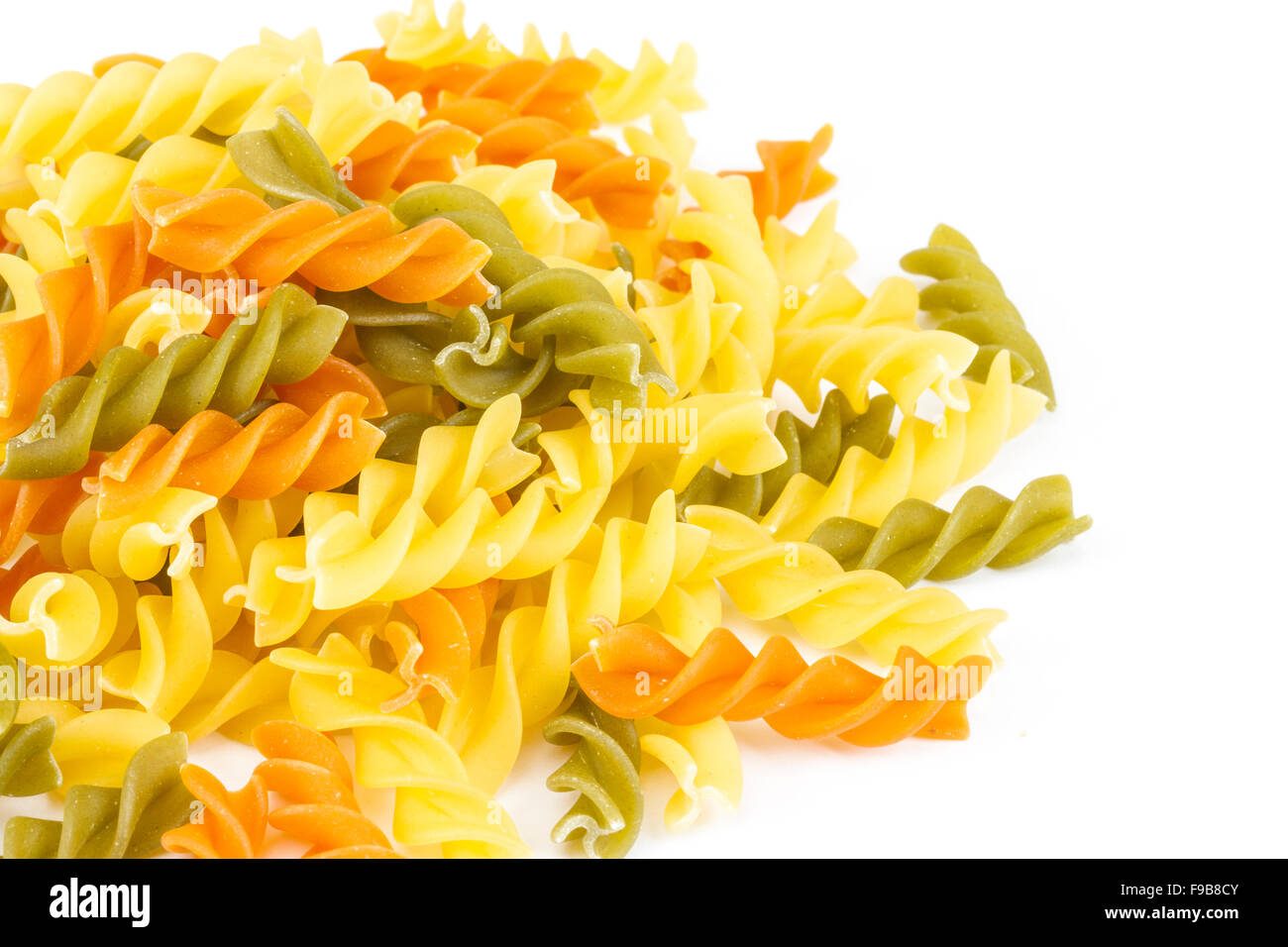 Uncooked pasta fusilli in different colours, white background Stock ...