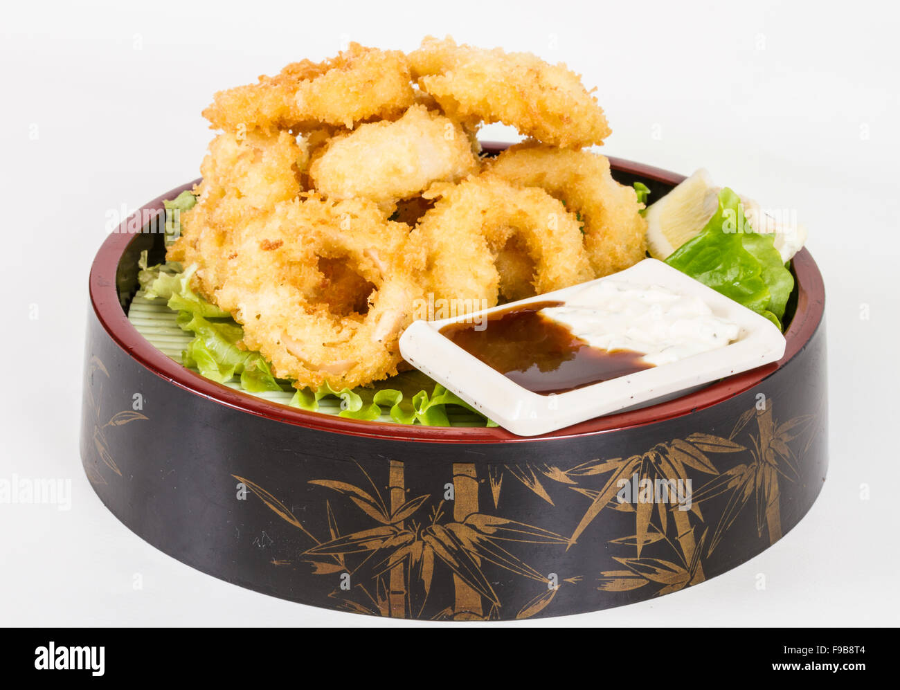 Deep batter fried squid rings calamari with green salad Stock Photo - Alamy