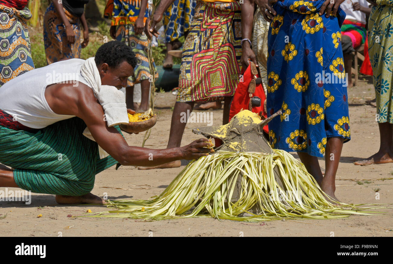 Man offering food to little spirit in Zangbeto ceremony, Heve-Grand ...