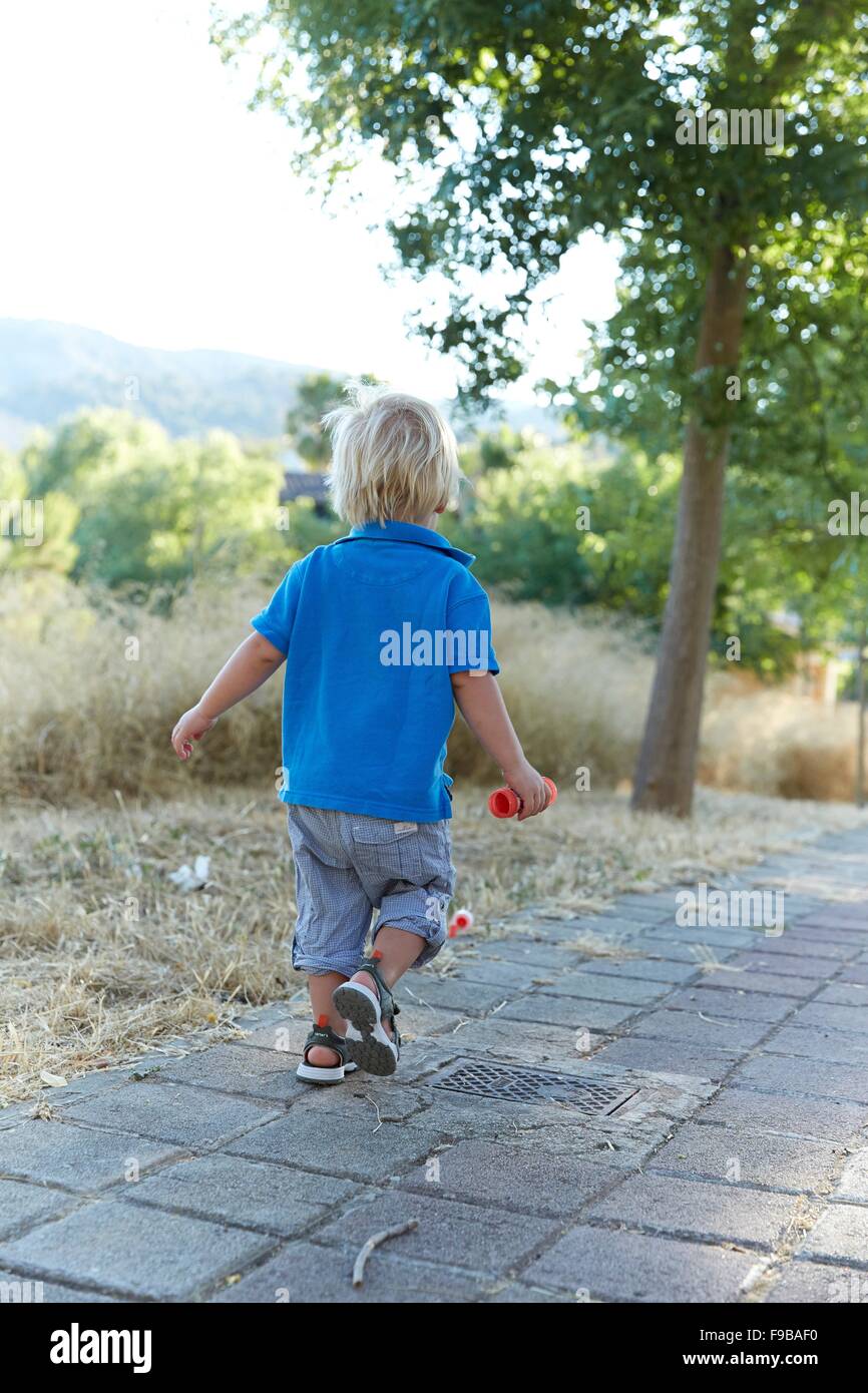 MODEL RELEASED. Boy walking on path Stock Photo - Alamy