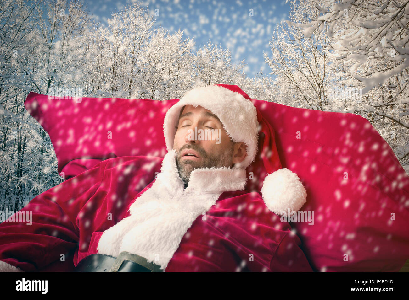 Santa Claus lying on sack and sleeping in the snow Stock Photo - Alamy