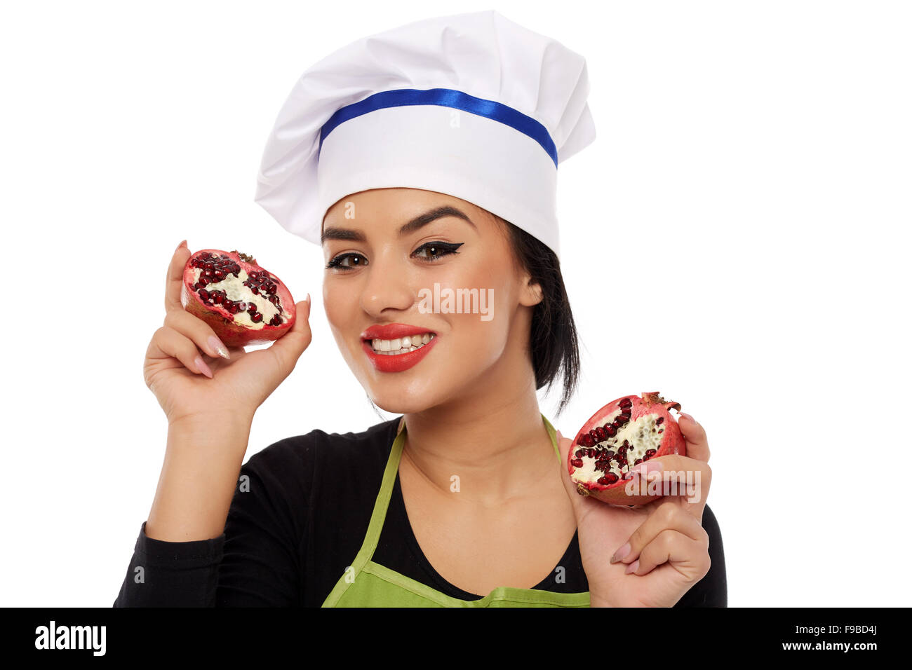 Young woman cook with sliced pomegranate fruit Stock Photo - Alamy