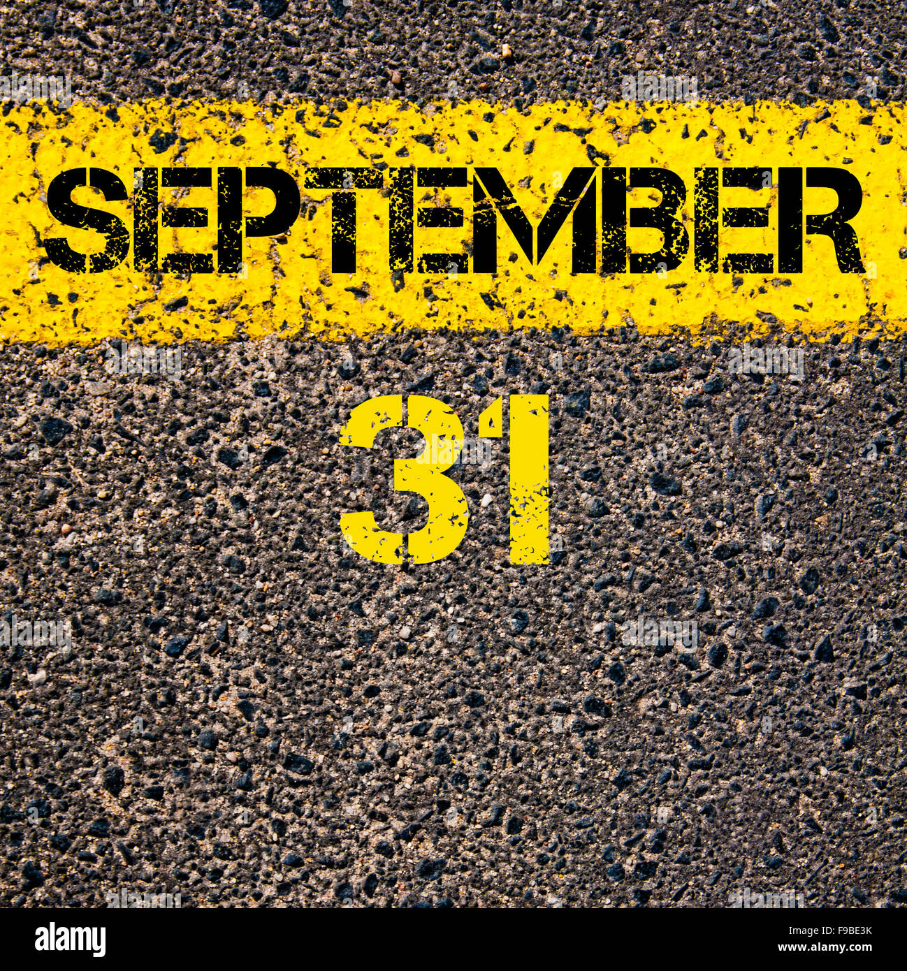 31 September calendar day written over road marking yellow paint line ...
