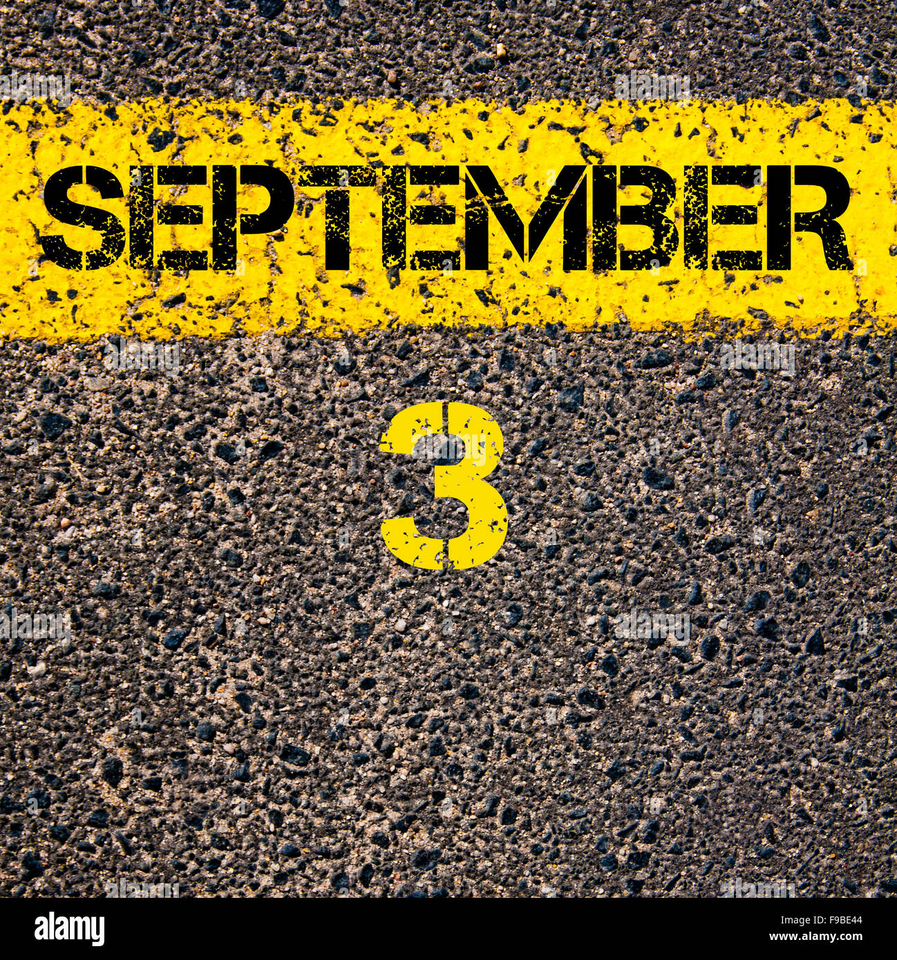 3 September calendar day written over road marking yellow paint line ...