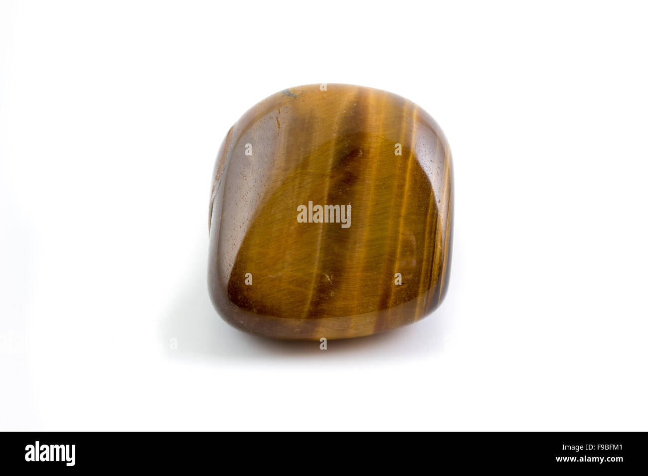 Tiger's eye gemstone close up white background. Gives confidence and ...