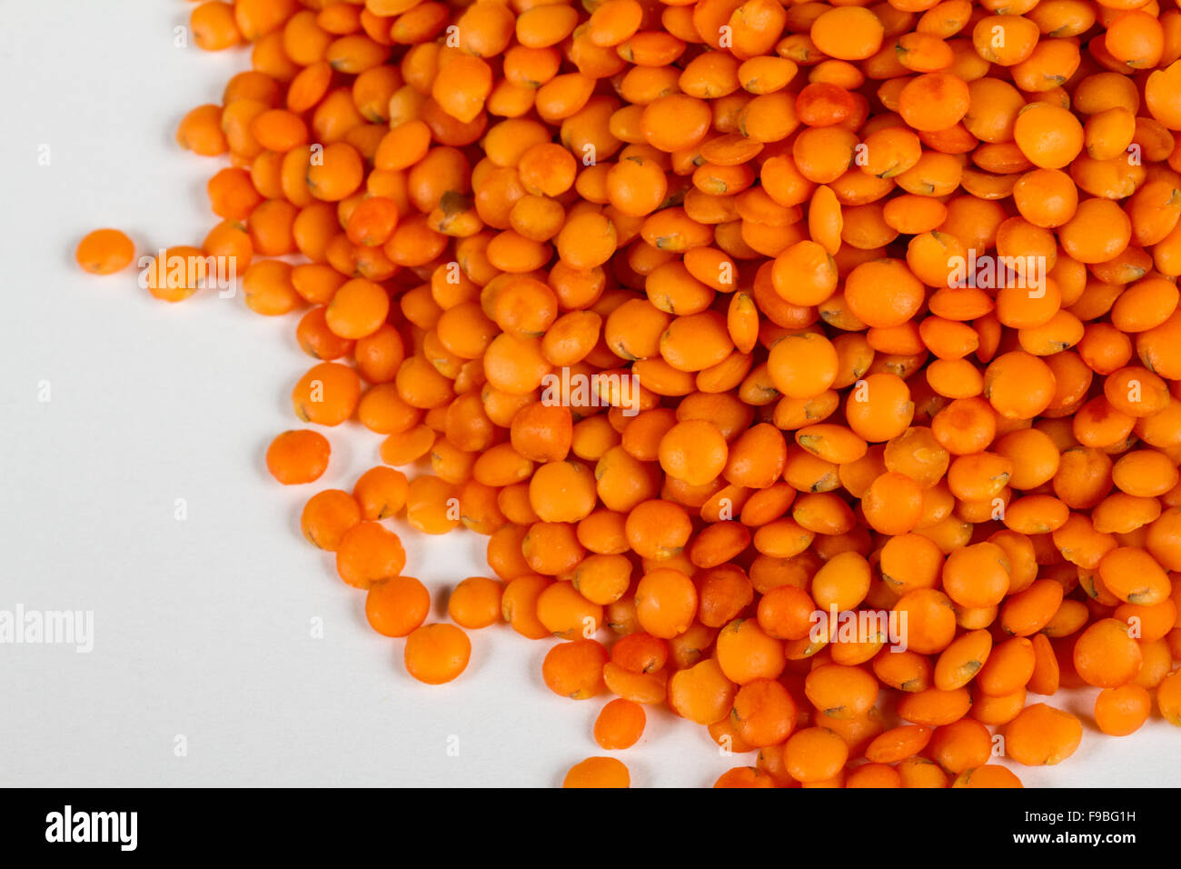 Heap of raw red lentils isolated on white background Stock Photo - Alamy