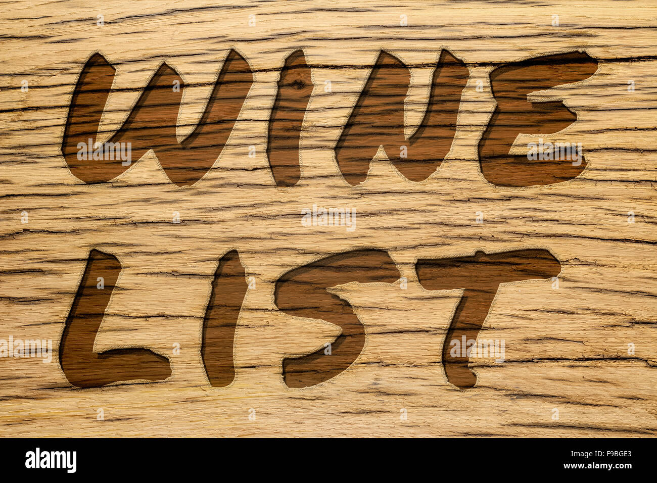 Wine list text carved into old oak wood background. Burnt effect on ...
