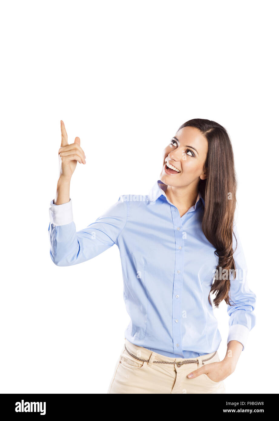 Beautiful young woman pointing to somewhere, isolated over a white ...