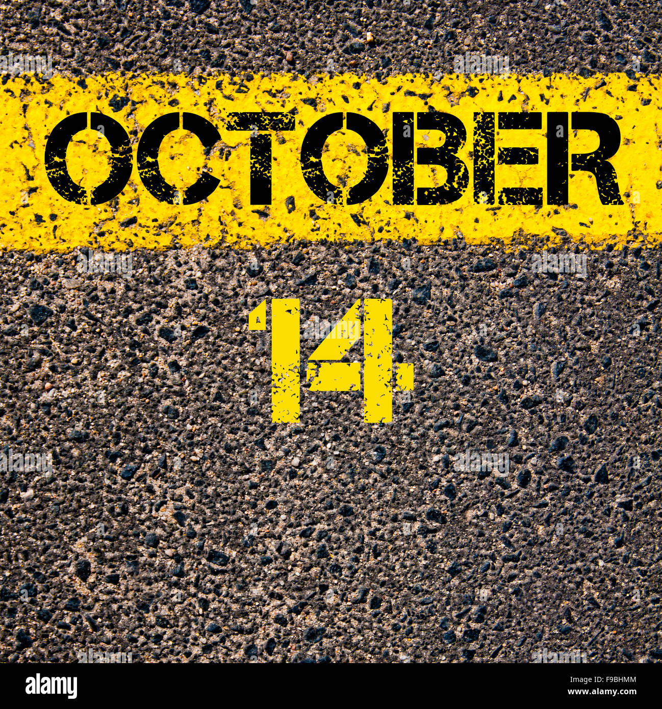14 October calendar day written over road marking yellow paint line ...