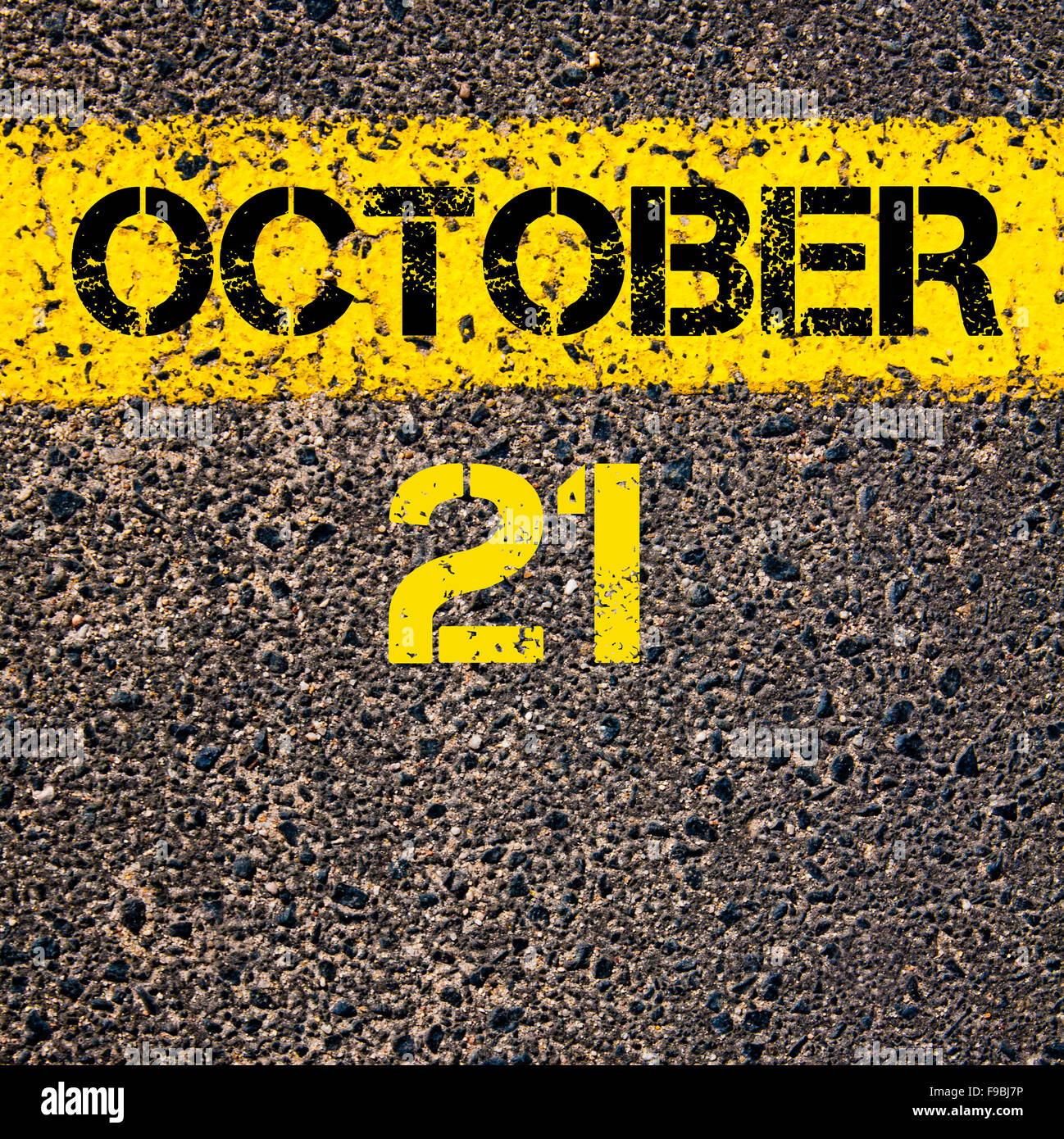 21 October calendar day written over road marking yellow paint line ...