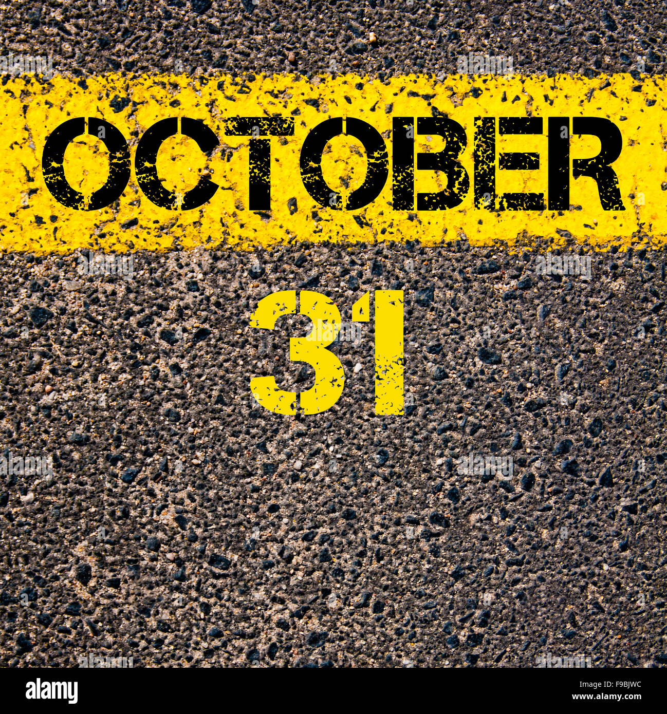 31 October calendar day written over road marking yellow paint line ...