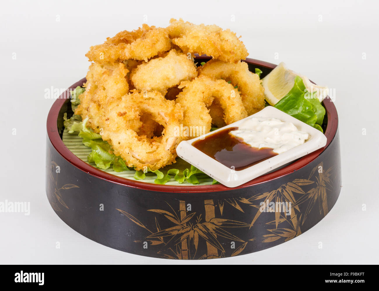 Deep batter fried squid rings calamari with green salad Stock Photo - Alamy