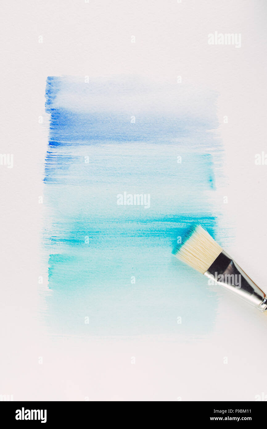 Blue abstract drawing and paintbrush on paper Stock Photo - Alamy