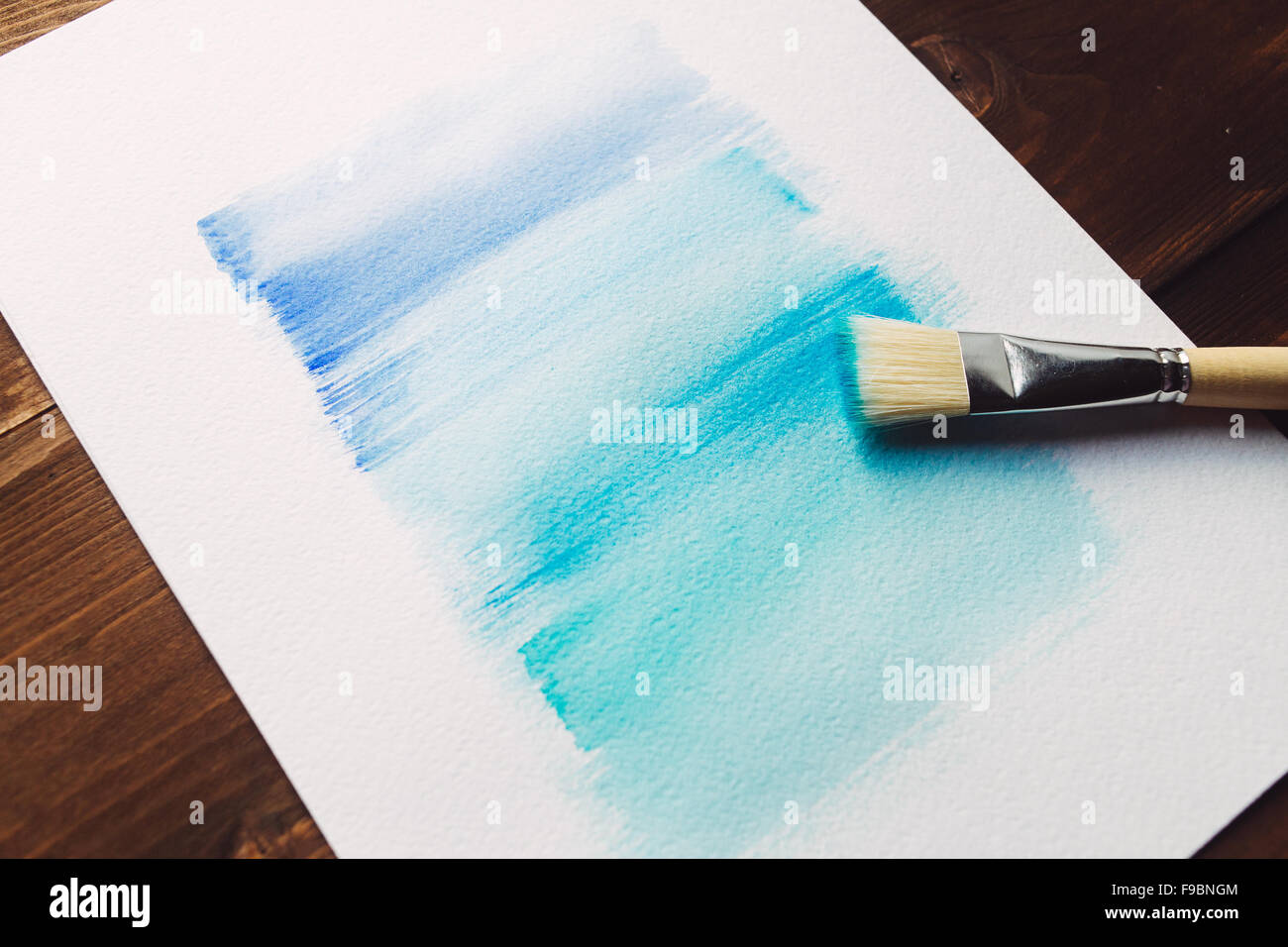 Blue abstract drawing and paintbrush on paper Stock Photo - Alamy