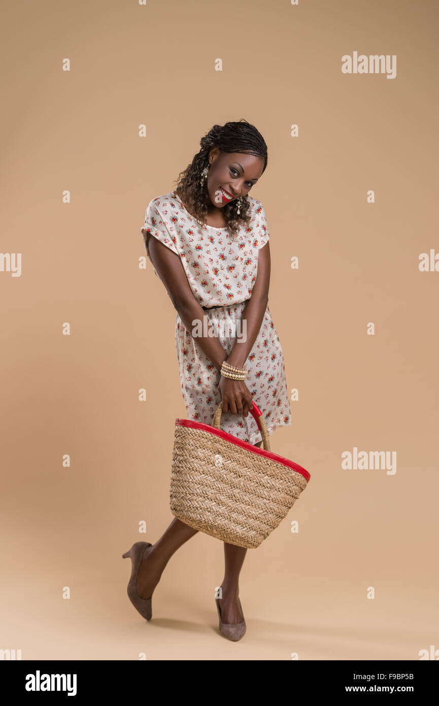 Portrait of cute african woman posing - standing with straw bag Stock ...