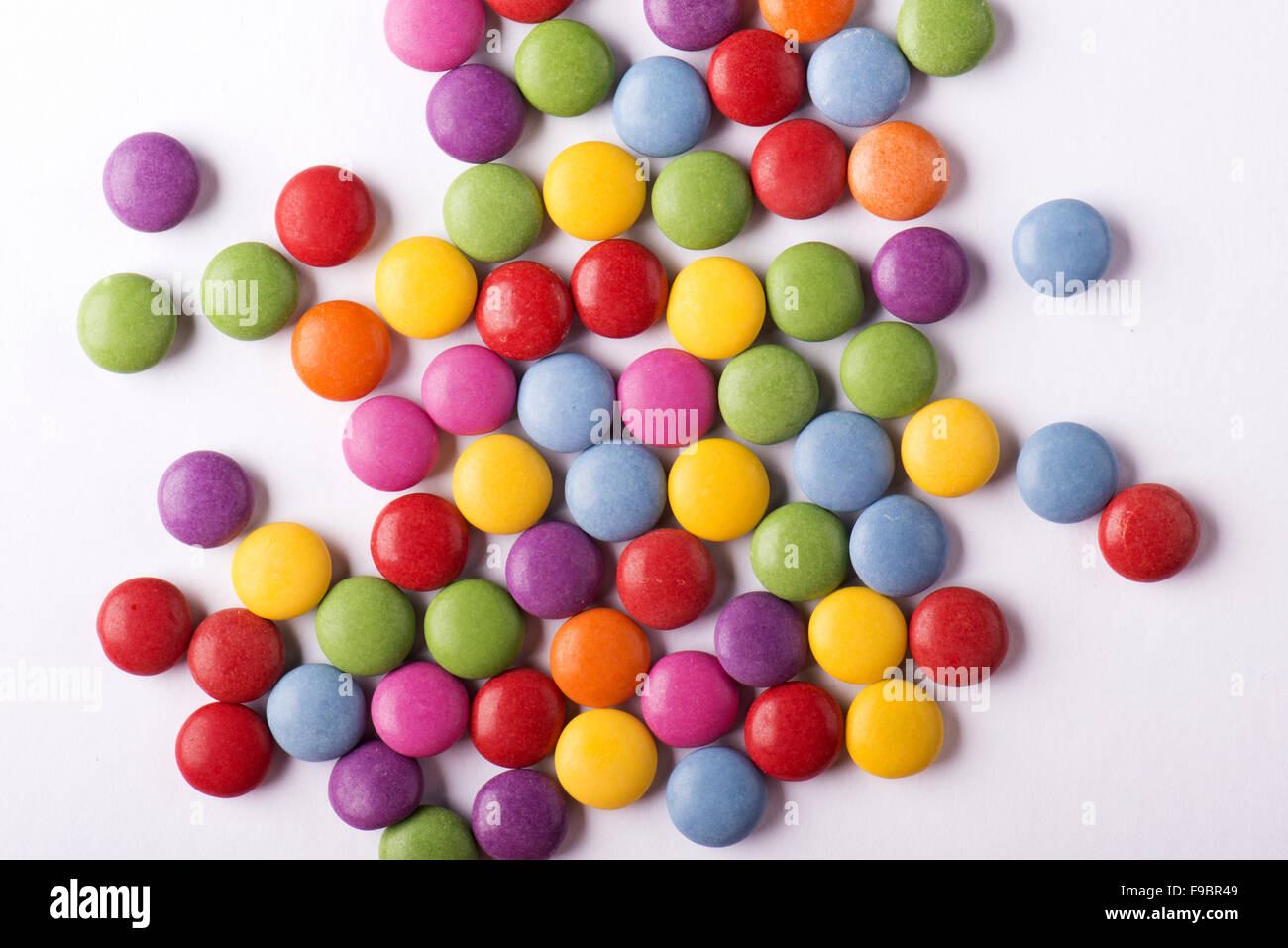 Studio concept with small round colorful candies Stock Photo - Alamy