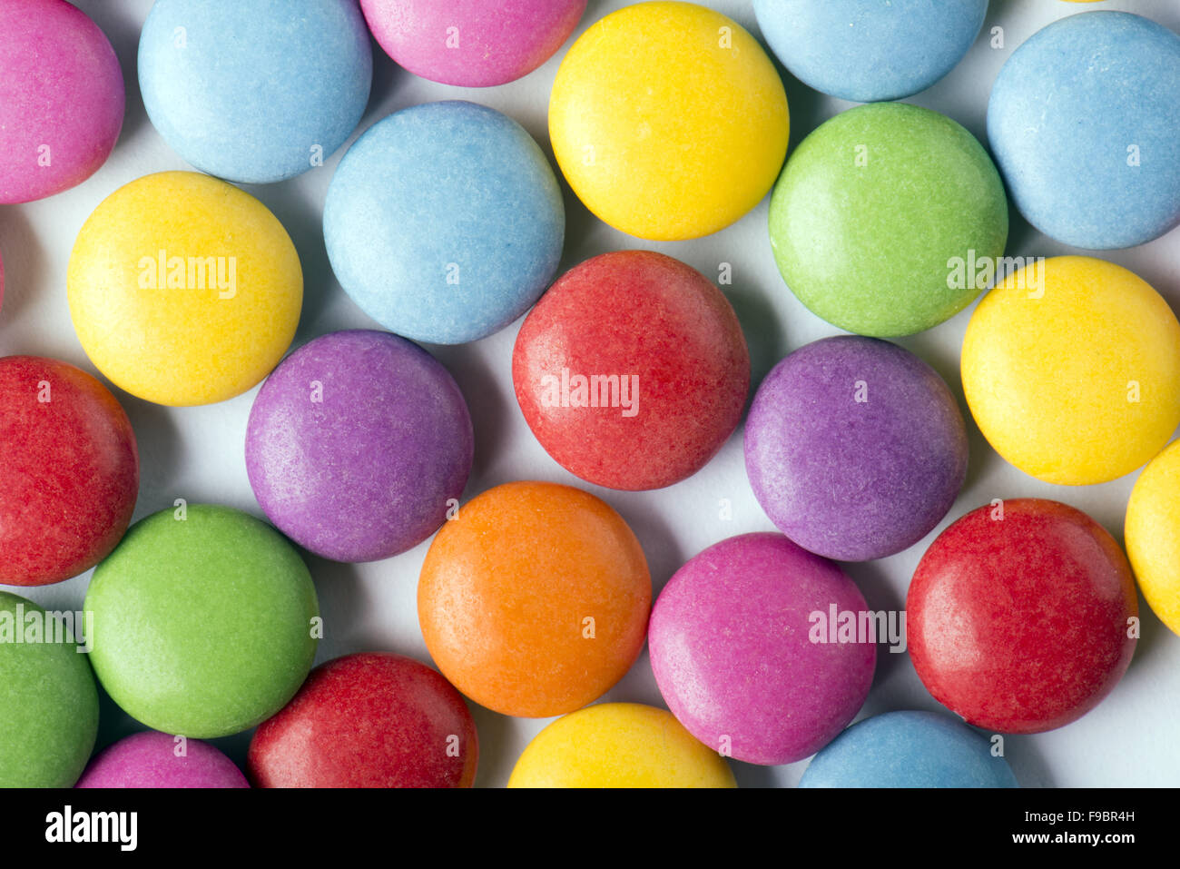 Studio concept with small round colorful candies Stock Photo - Alamy