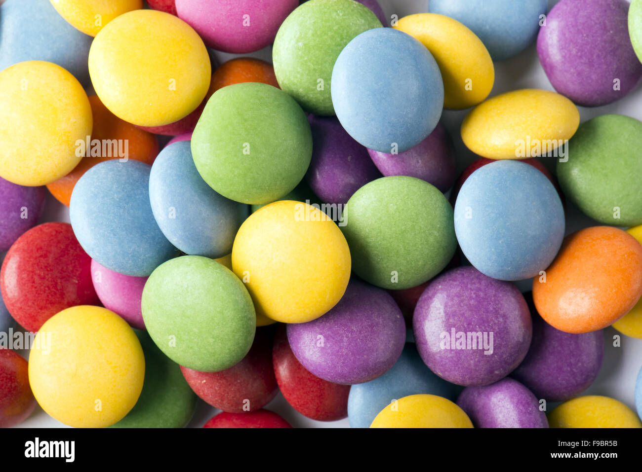 Studio concept with small round colorful candies Stock Photo - Alamy