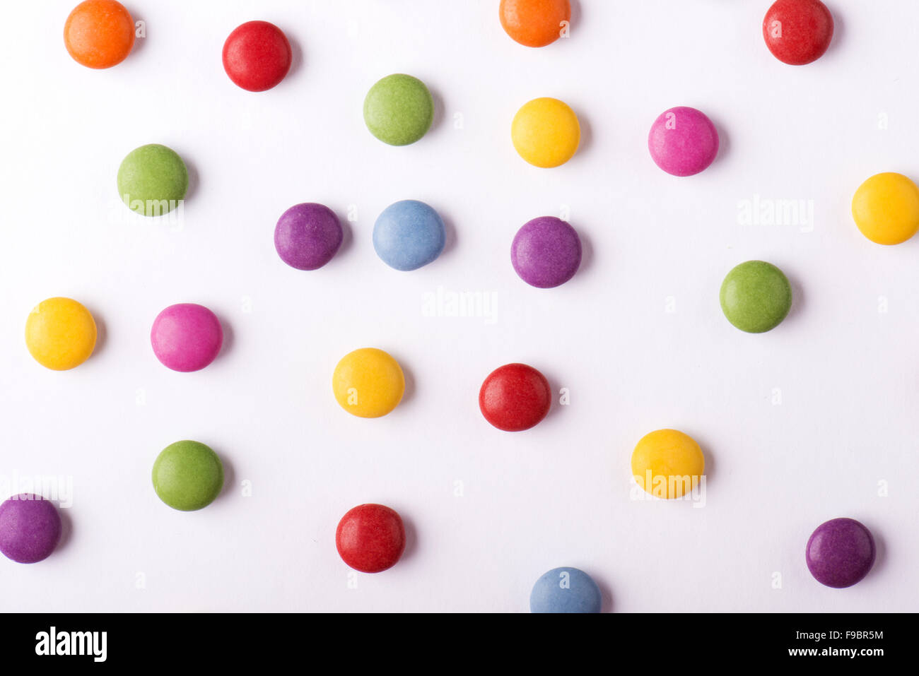 Studio concept with small round colorful candies Stock Photo - Alamy