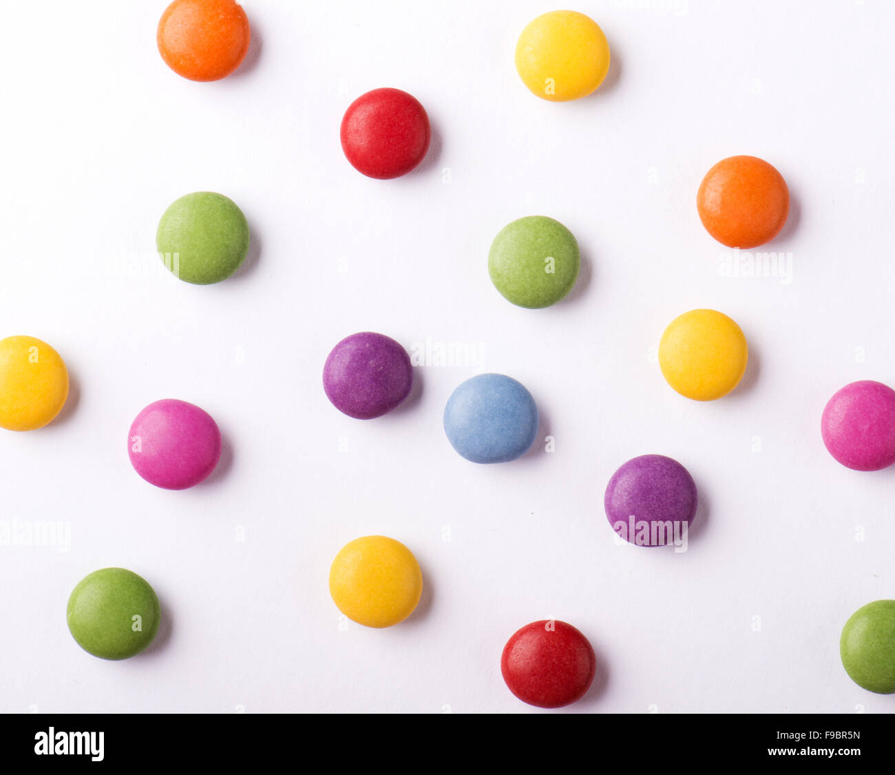 Studio concept with small round colorful candies Stock Photo - Alamy
