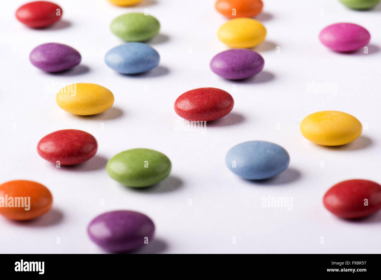 Studio concept with small round colorful candies Stock Photo - Alamy