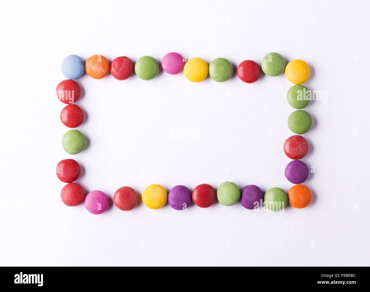 Studio concept with small round colorful candies Stock Photo - Alamy