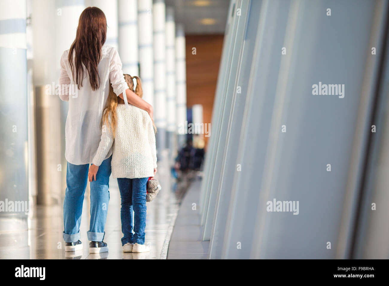 Happy family at airport waiting for boarding Stock Photo - Alamy
