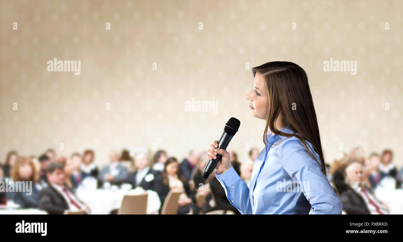 Beautiful business woman is speaking on conference Stock Photo - Alamy