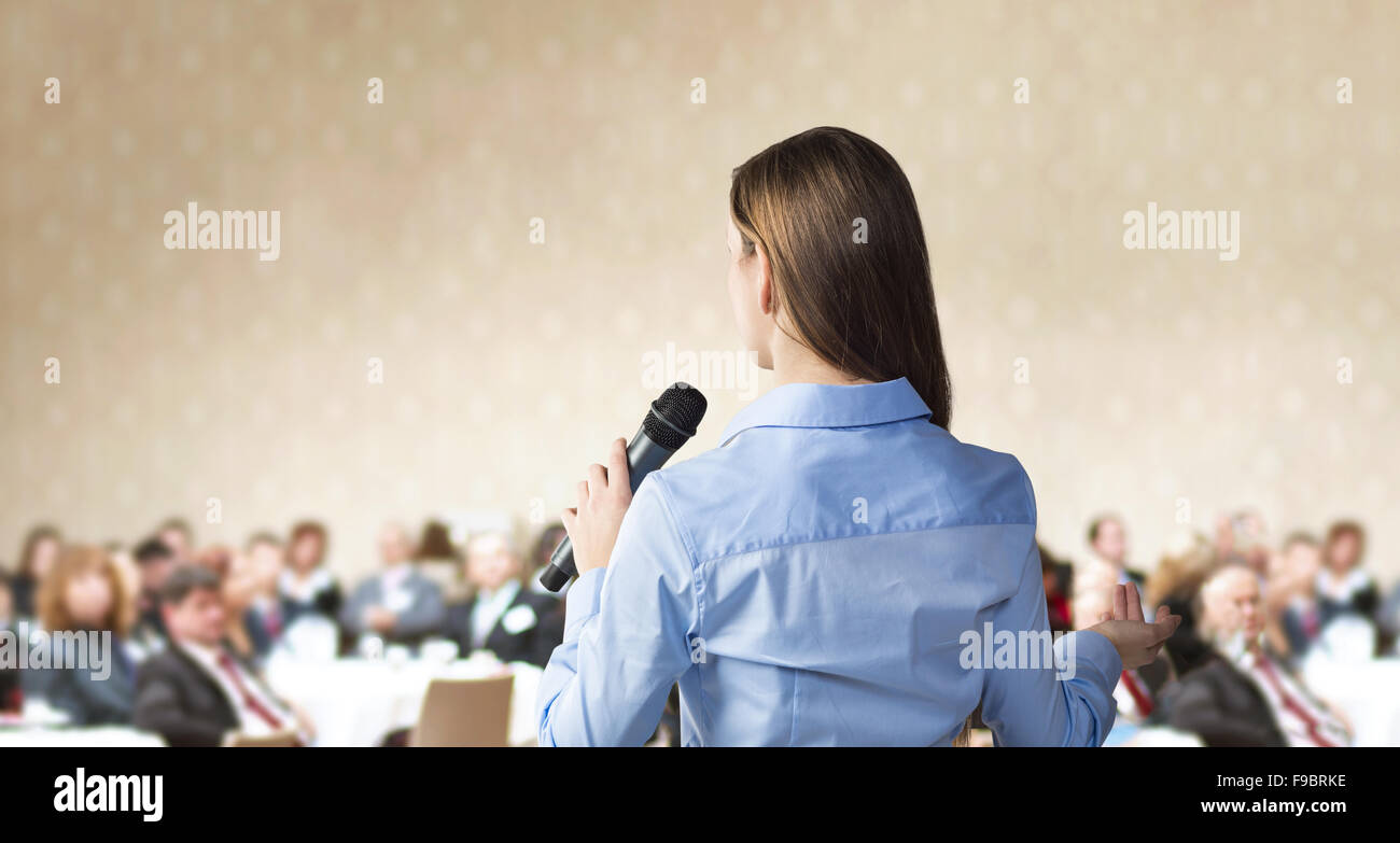 Beautiful business woman is speaking on conference Stock Photo - Alamy
