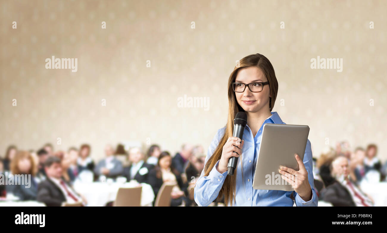Beautiful business woman is speaking on conference Stock Photo - Alamy
