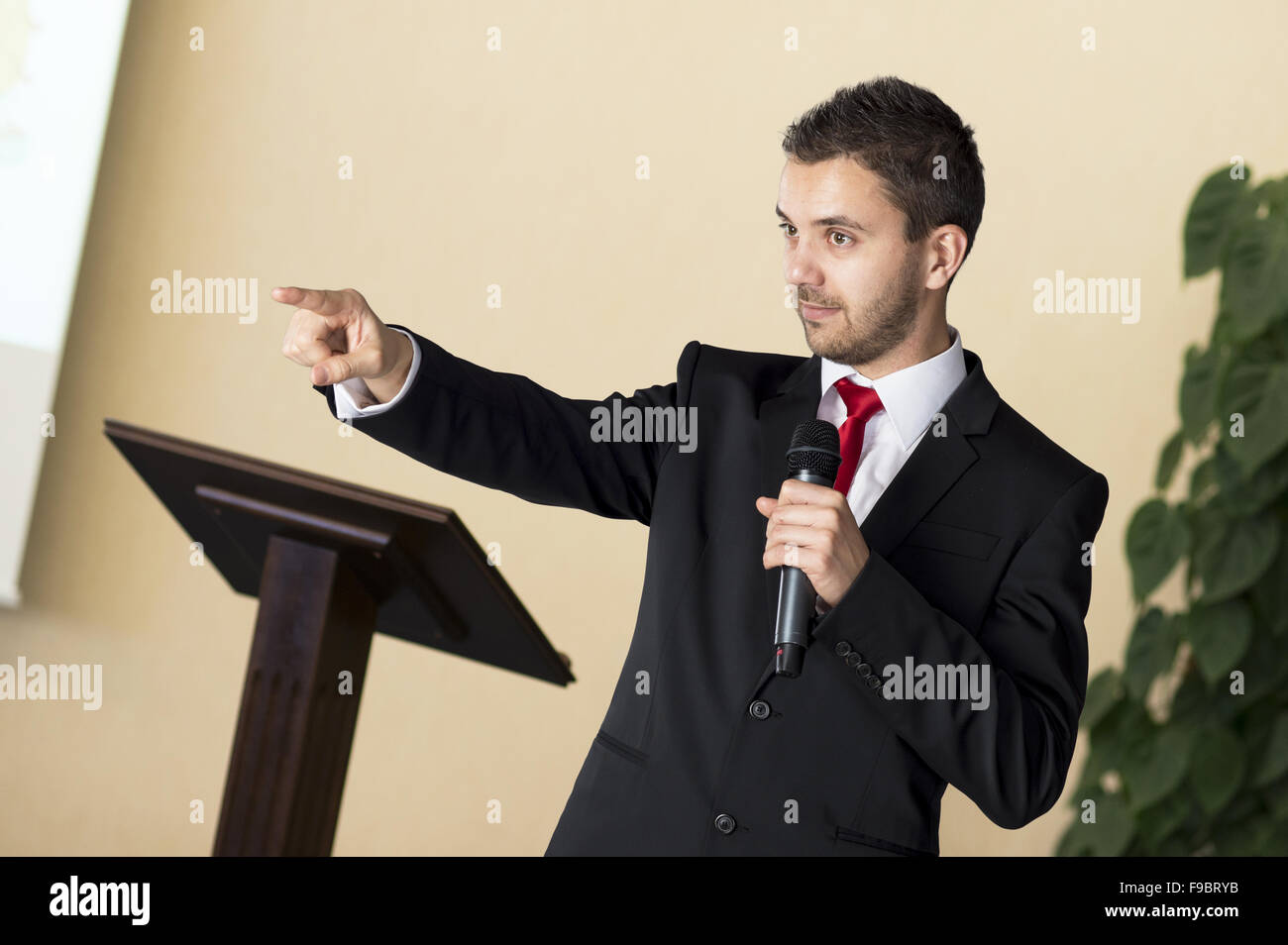 Handsome businessman is speaking on conference in hotel Stock Photo - Alamy