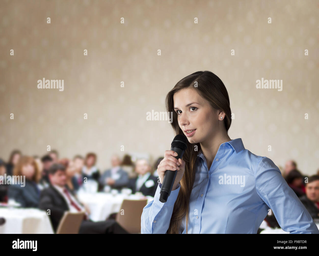Beautiful business woman is speaking on conference Stock Photo - Alamy