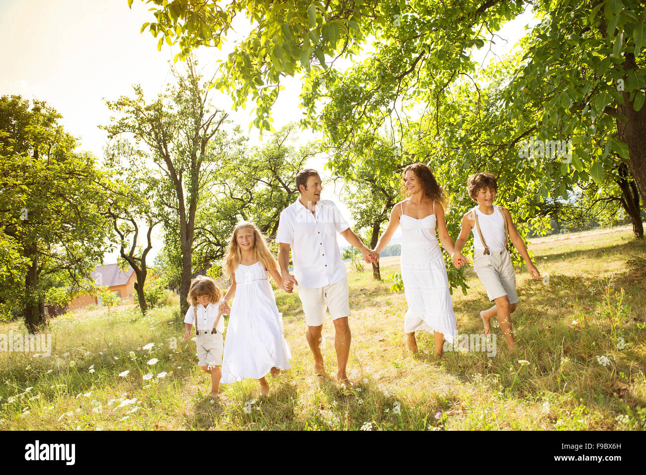 Happy young family spending time outdoor on a summer day Stock Photo ...