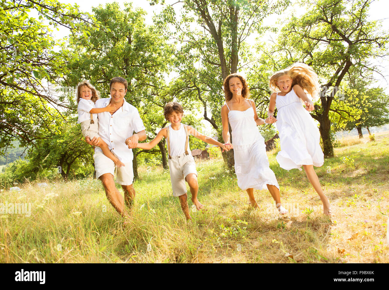 Happy young family spending time outdoor on a summer day Stock Photo ...