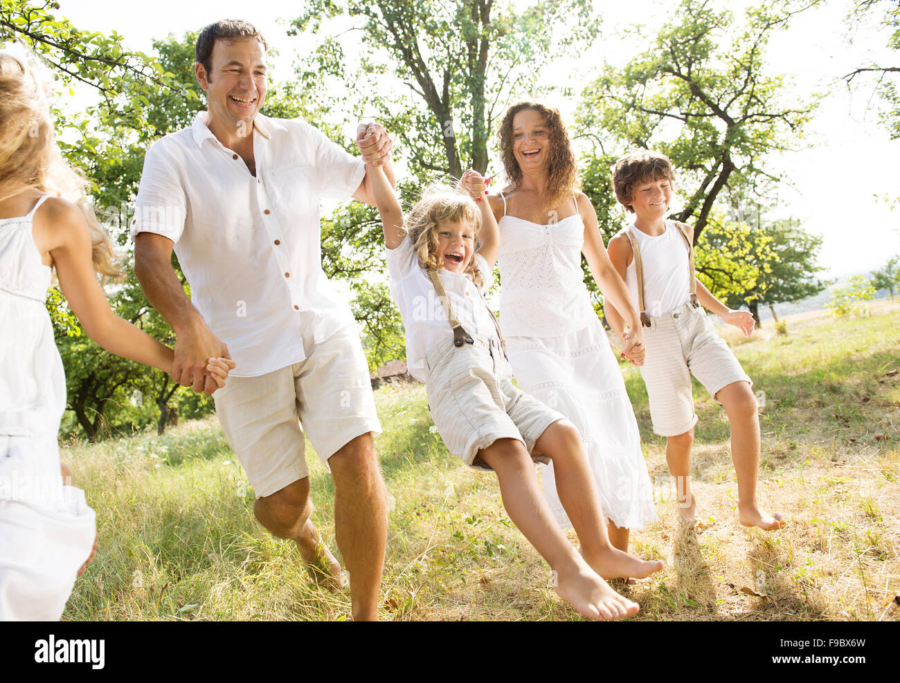 Happy young family spending time outdoor on a summer day Stock Photo ...