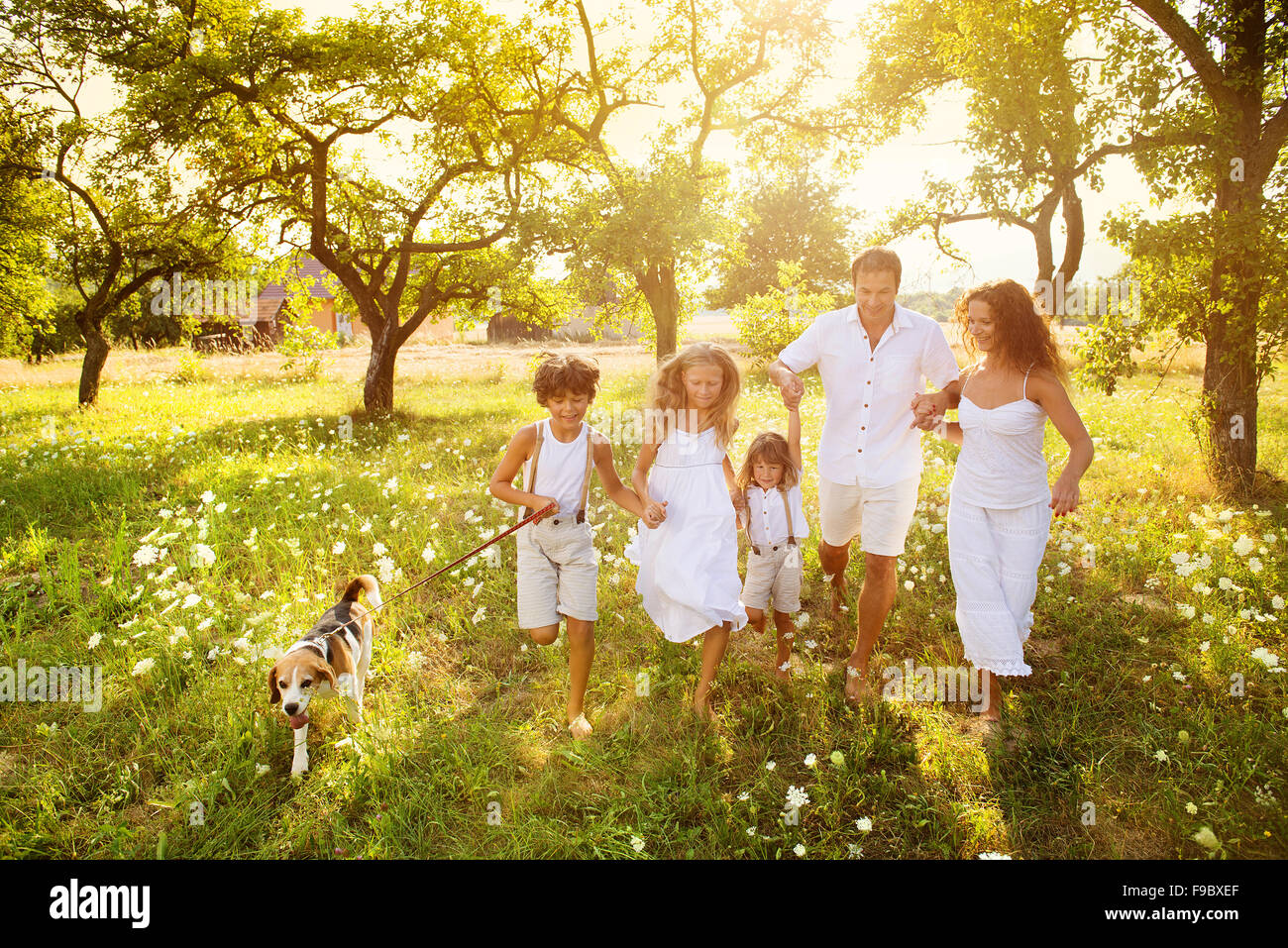 Happy young family spending time outdoor on a summer day Stock Photo ...