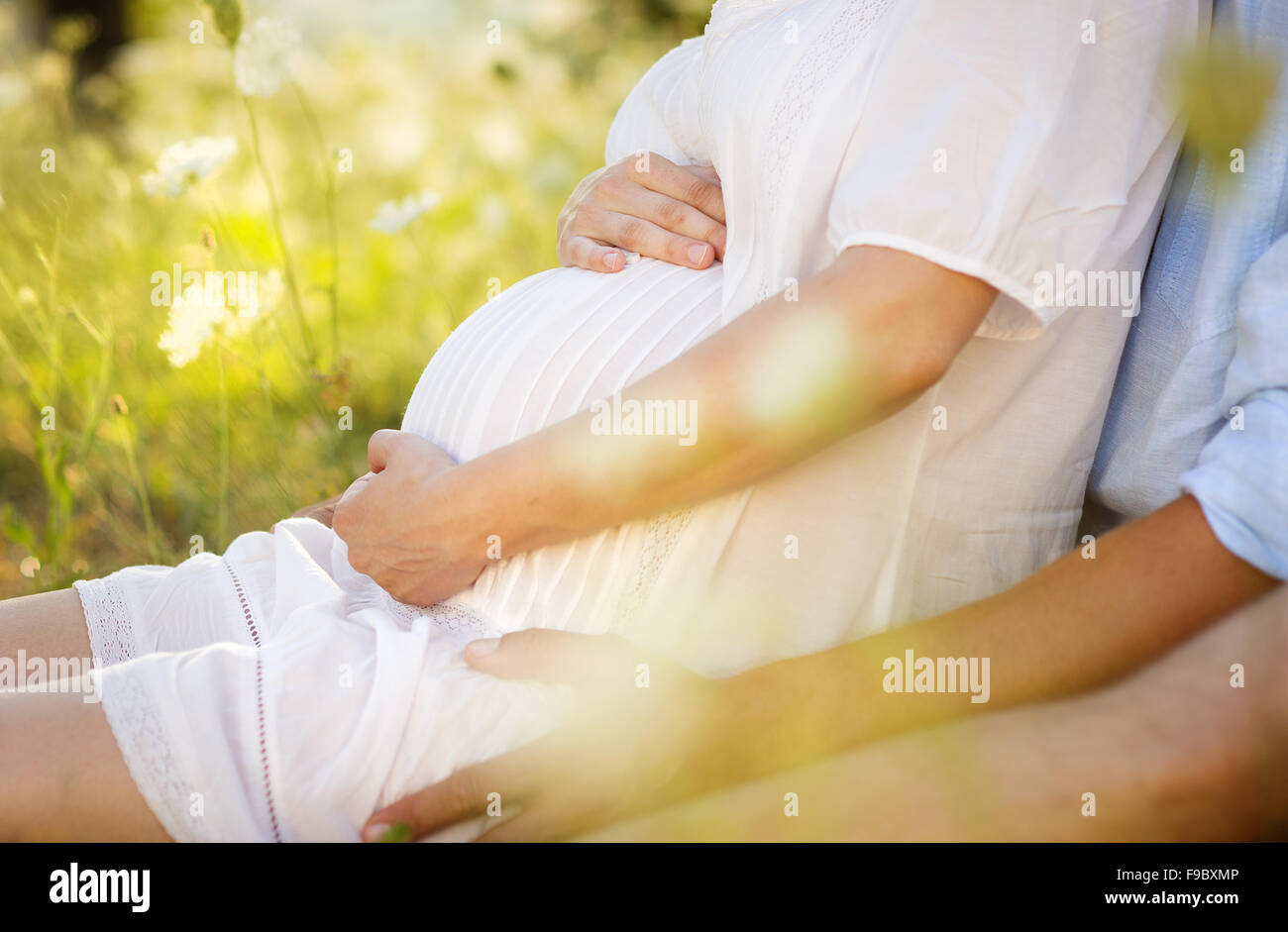 Close up of human hands holding pregnant belly Stock Photo - Alamy
