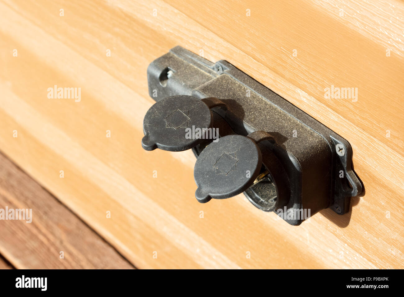 black waterproof outdoor electrical outlet with a rubber cap Stock ...