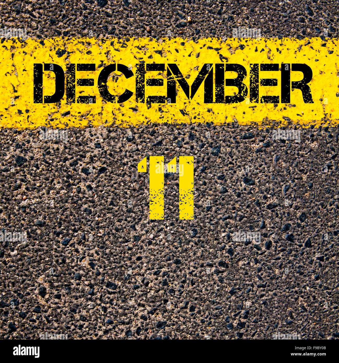 11 December calendar day written over road marking yellow paint line ...