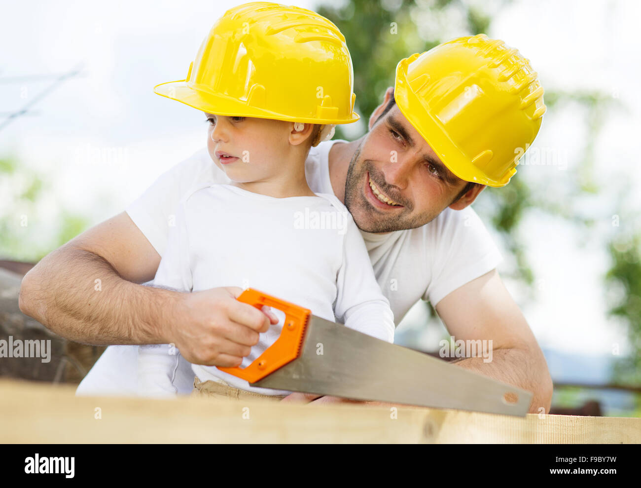 Baby helping daddy work hi-res stock photography and images - Alamy