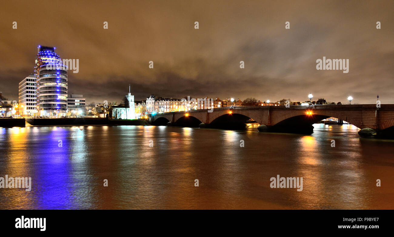 Putney Bridge at night, seen from across the River Thames in London ...